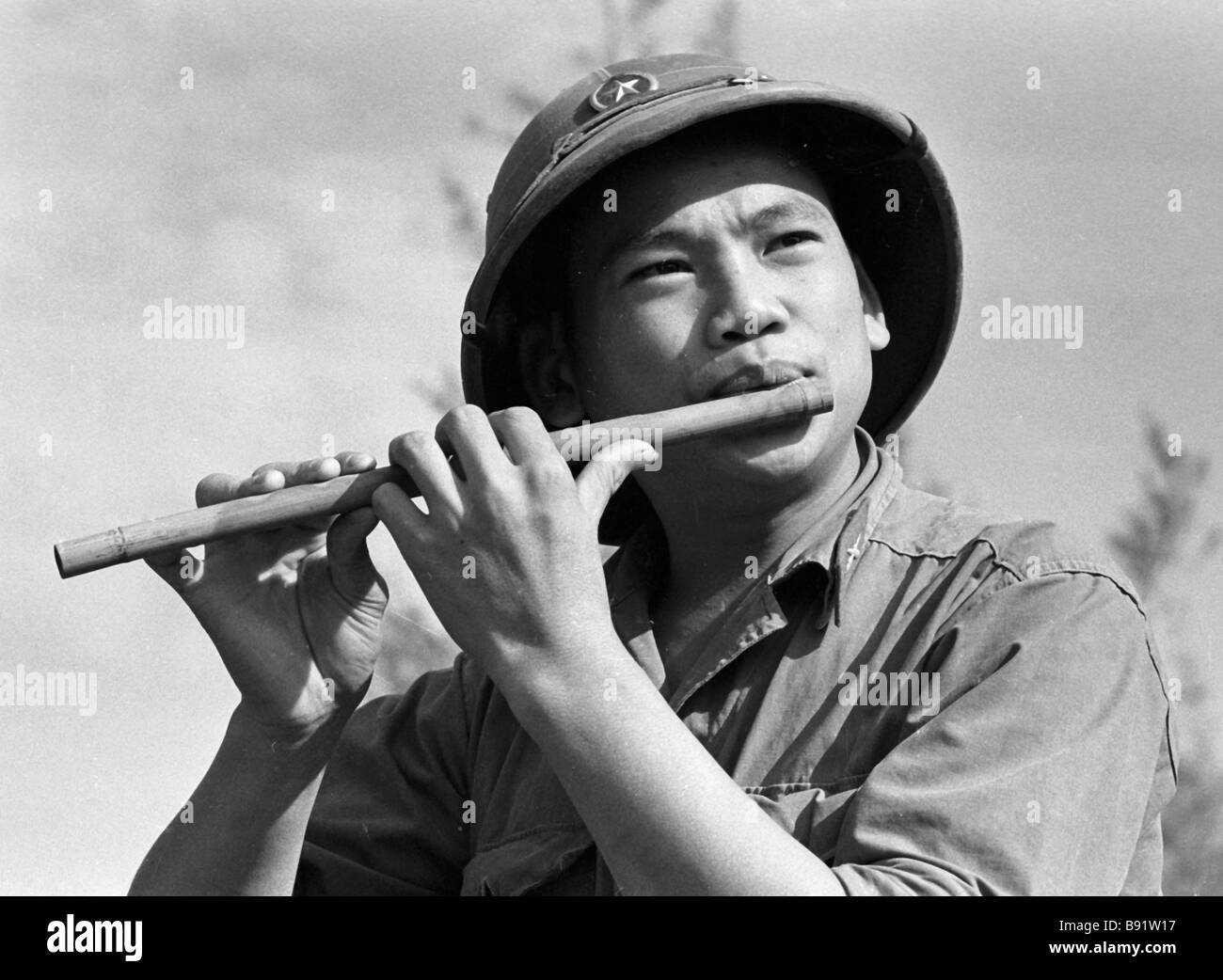 A Vietnamese soldier playing a reed pipe Stock Photo - Alamy