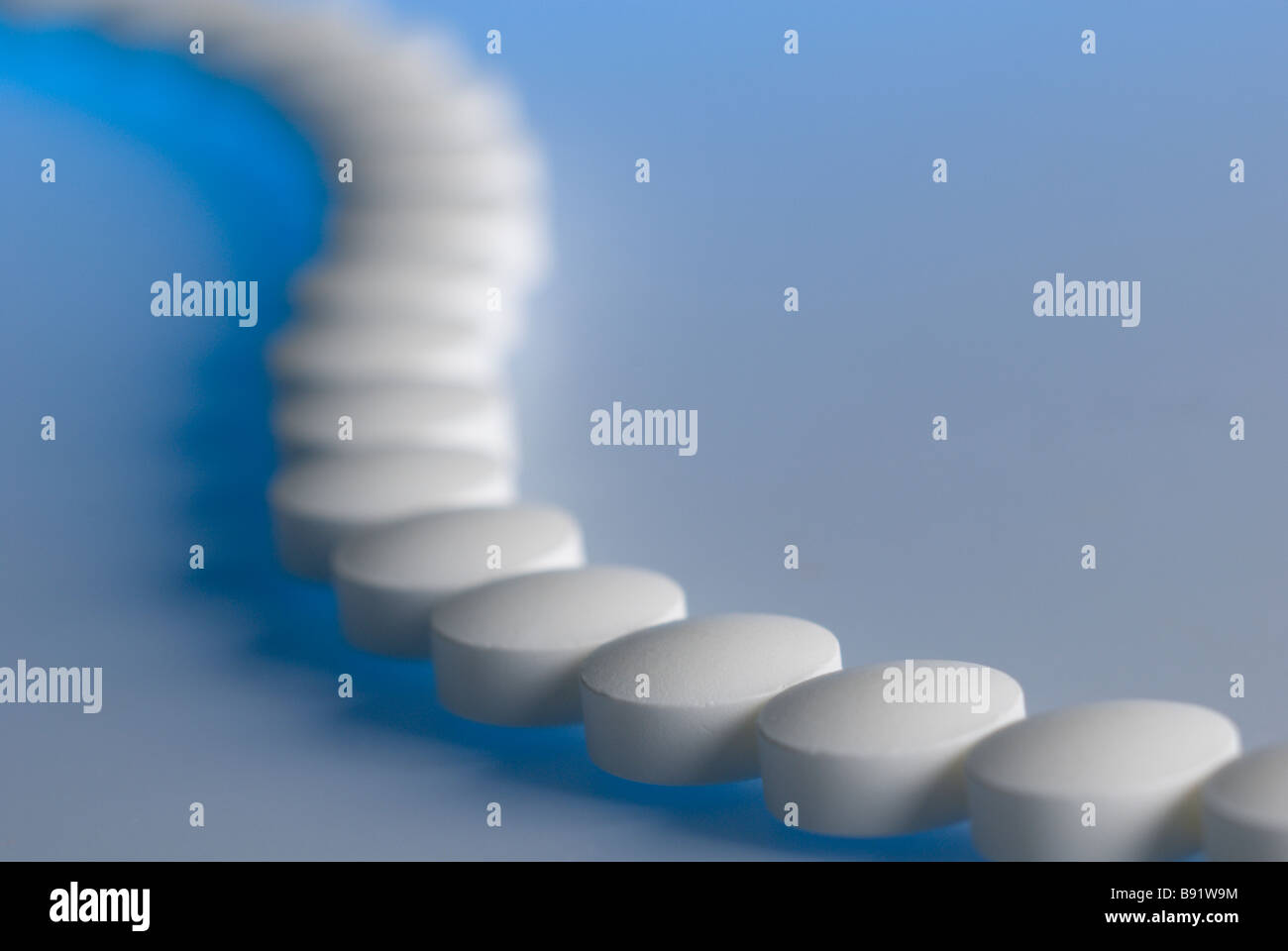 Aspirin on a blue background Stock Photo - Alamy