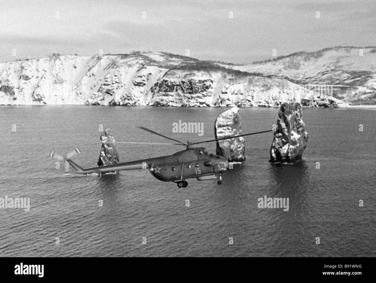Helicopter flying over the sea Stock Photo - Alamy