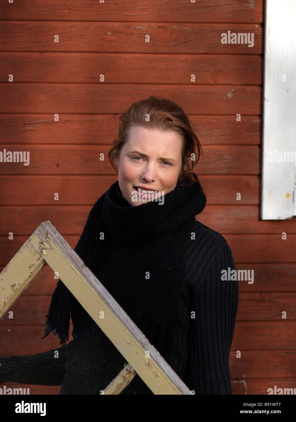 A young woman holding a window frame Sweden Stock Photo - Alamy