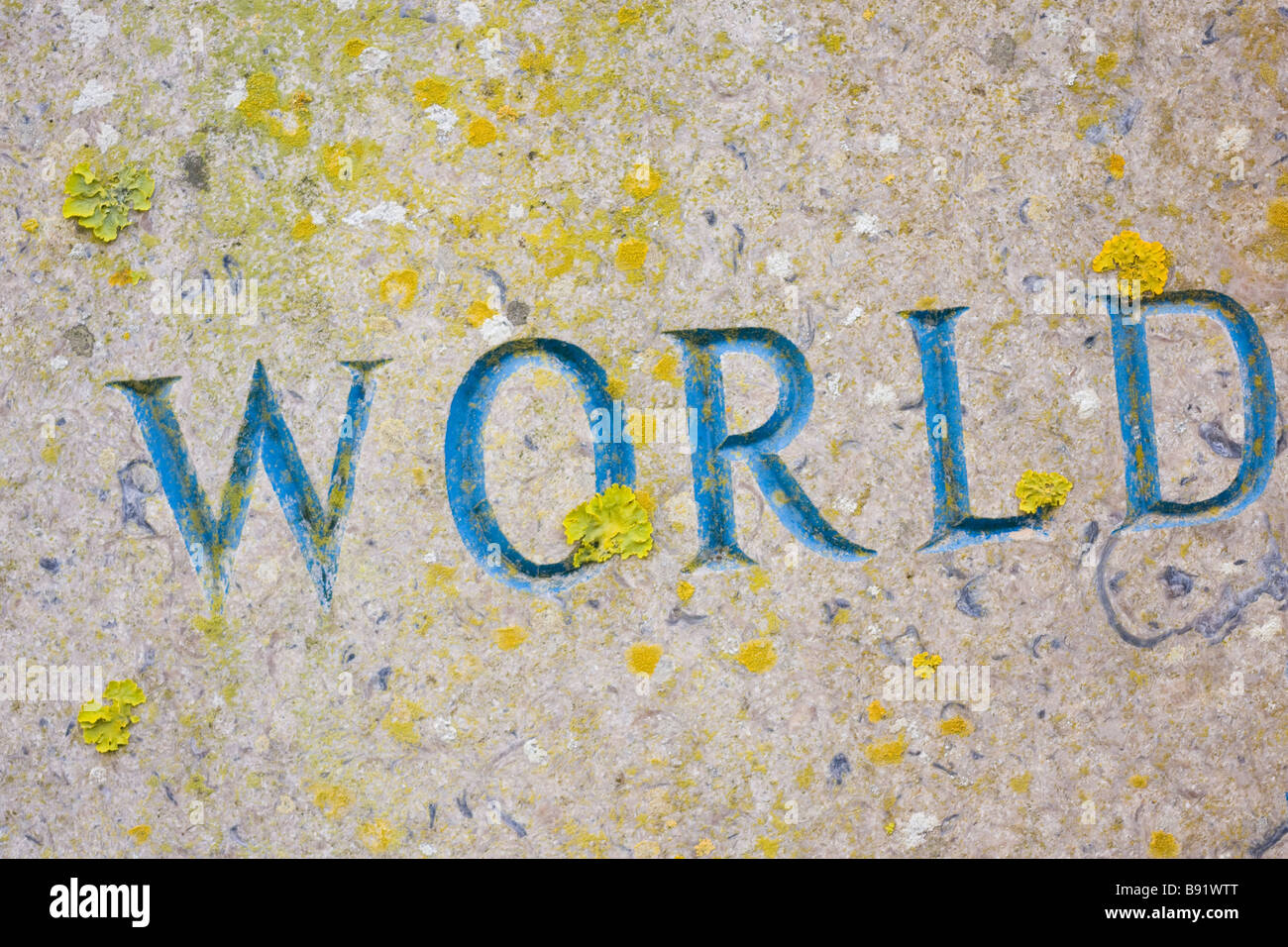 The word "world" engraved in stone Stock Photo - Alamy