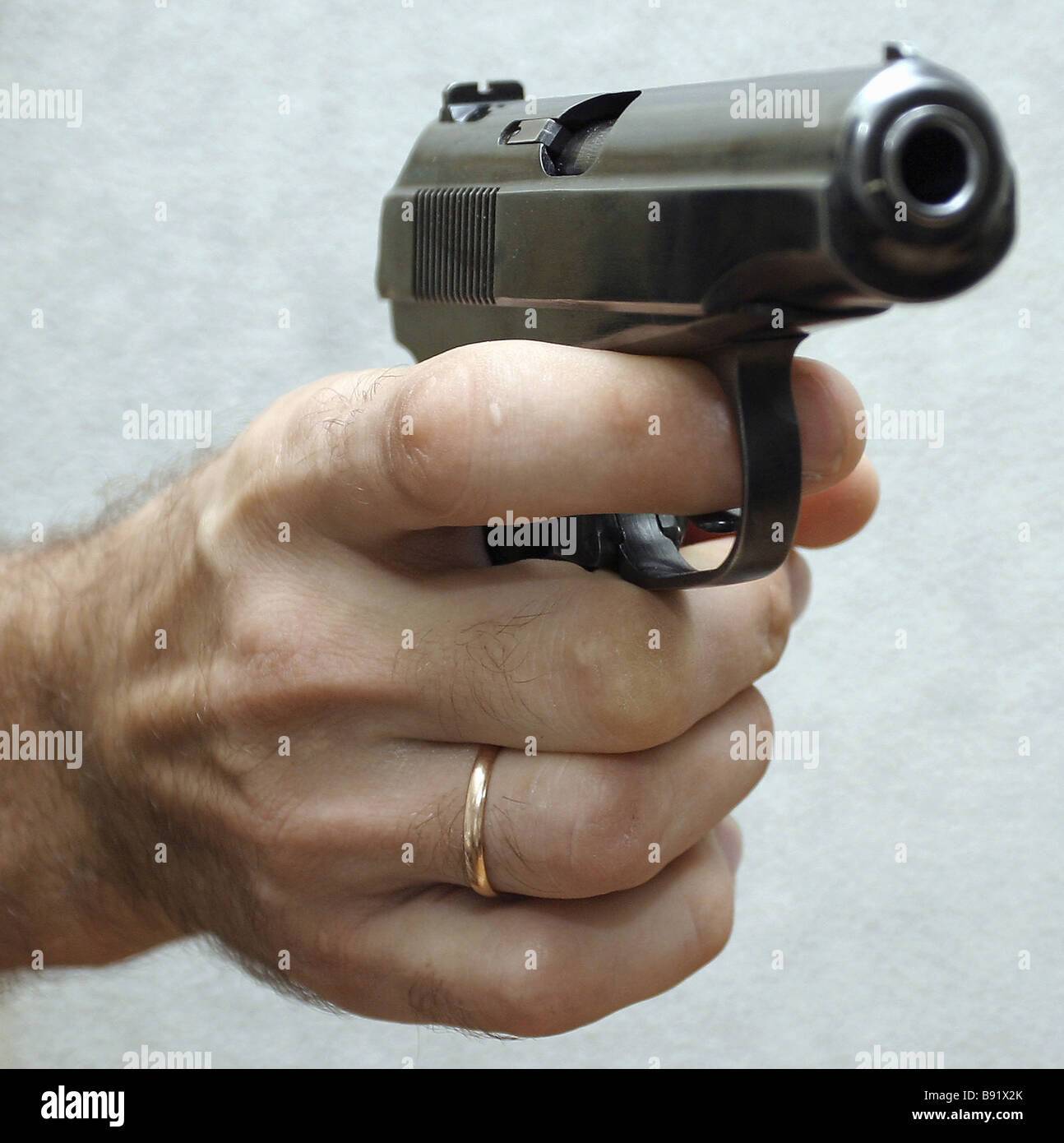 A pistol in a hand Stock Photo - Alamy