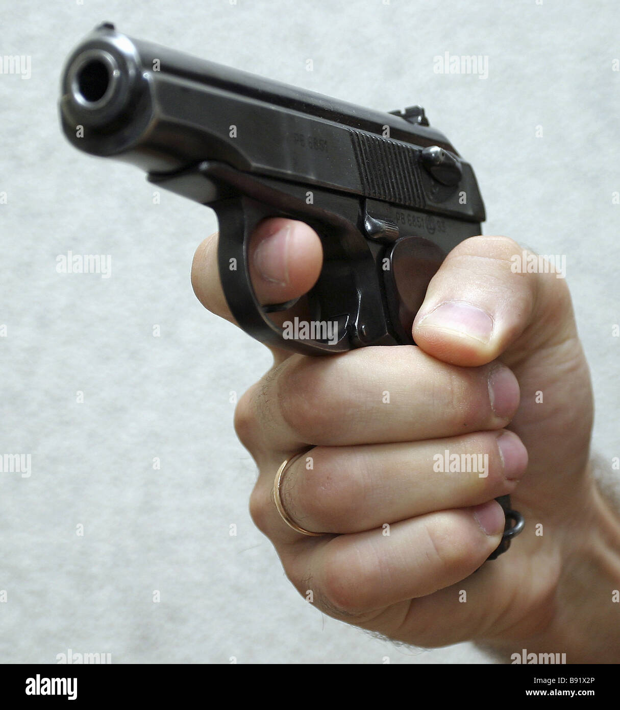 A pistol in a hand Stock Photo - Alamy