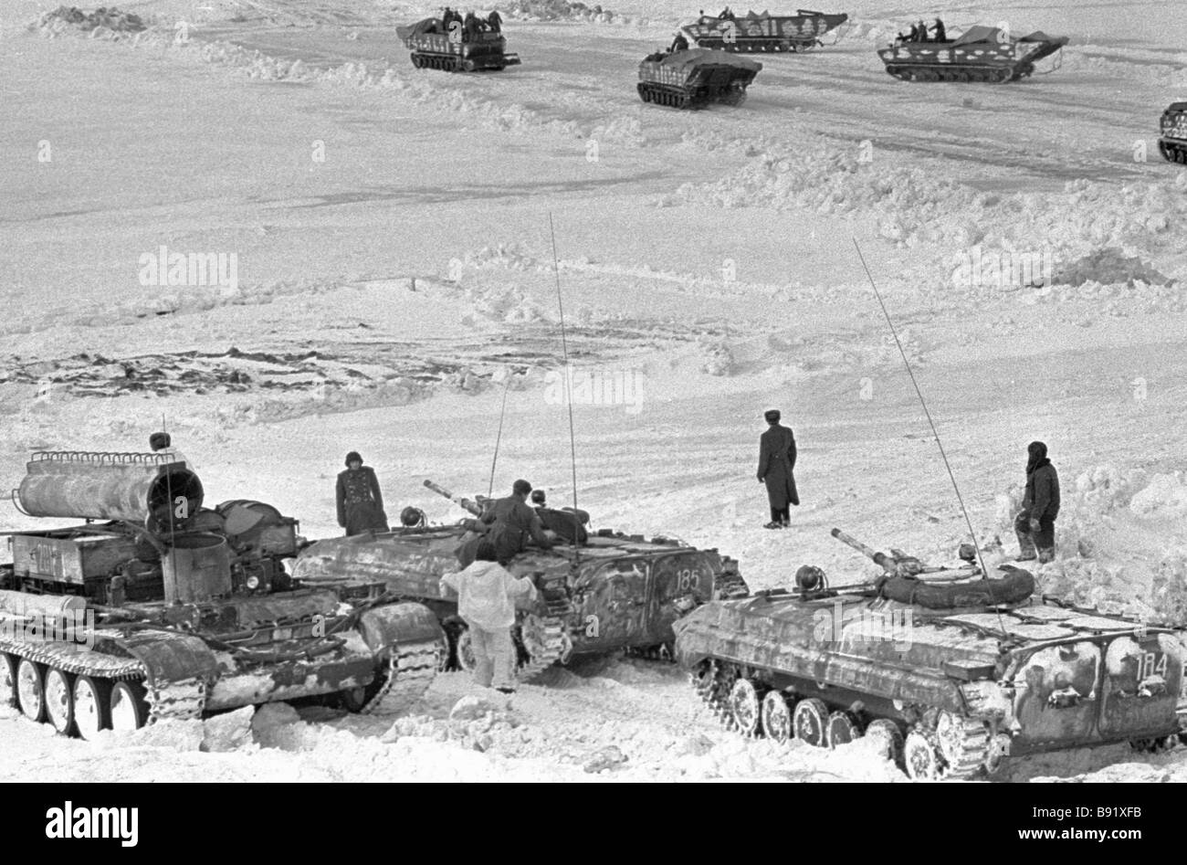Infantry fighting and amphibious vehicles crossing ice during the ...