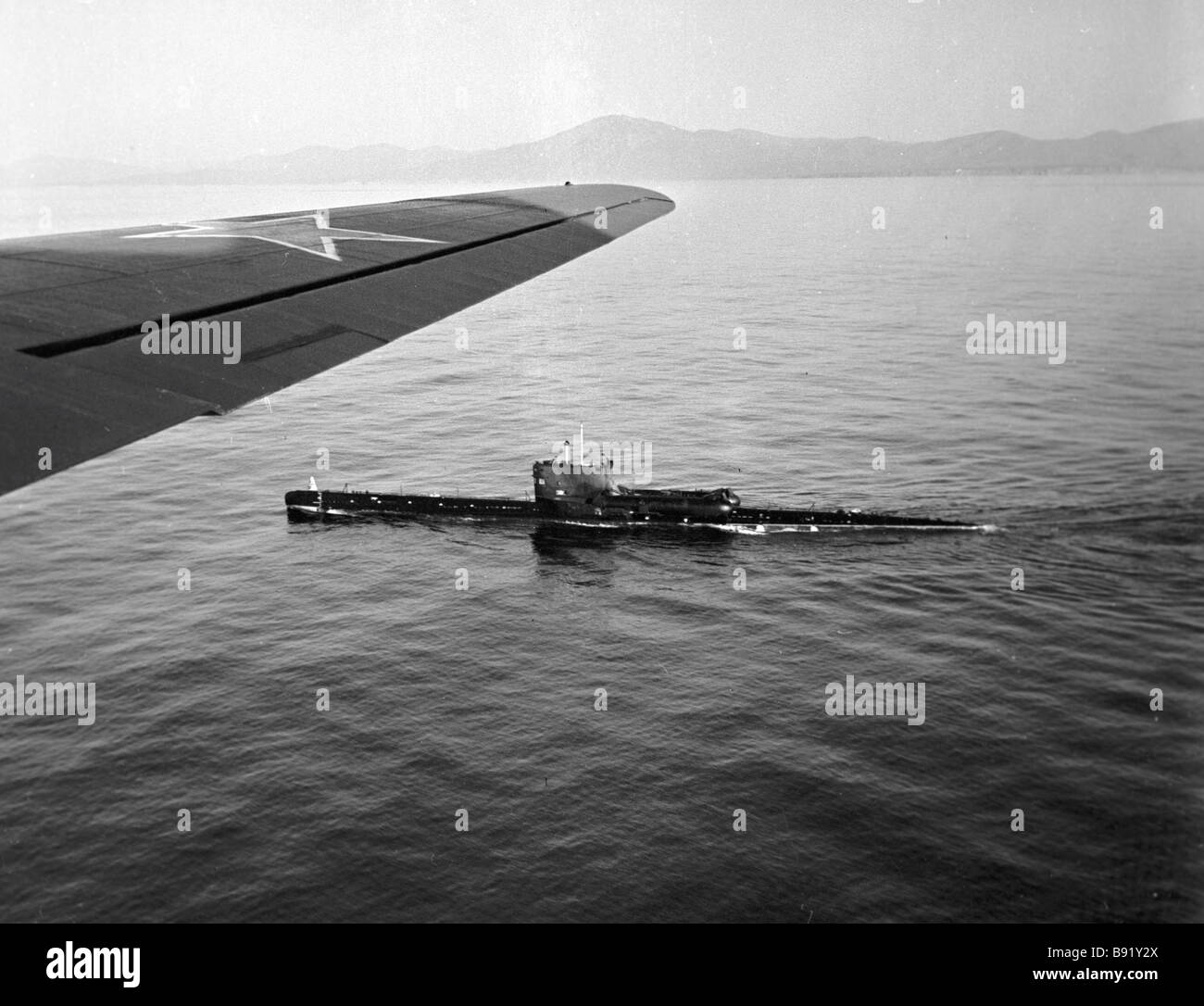 Submarine surfaces in exercise area Stock Photo - Alamy
