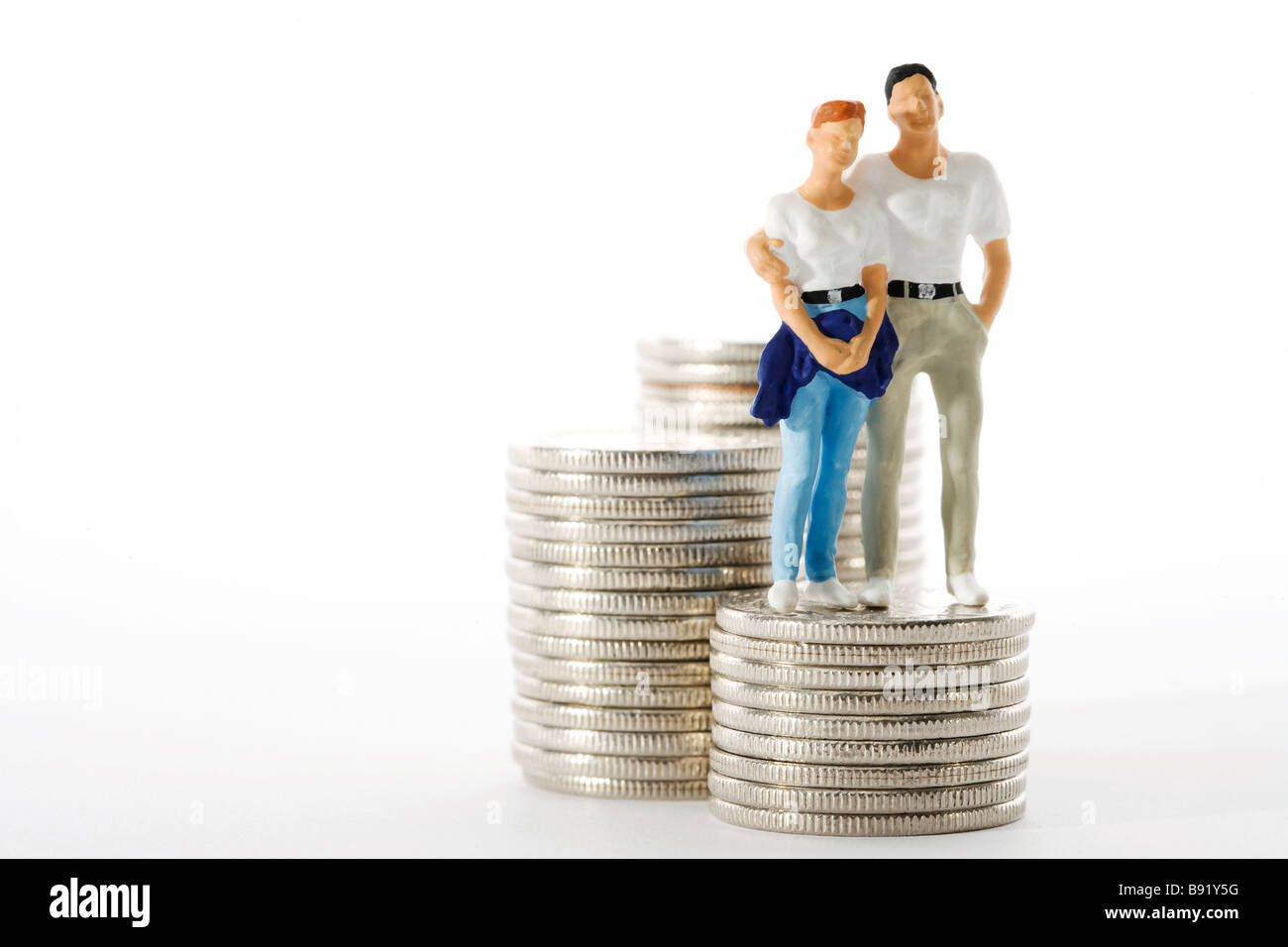 Figures in the shape of a couple standing next to a bunch of money ...