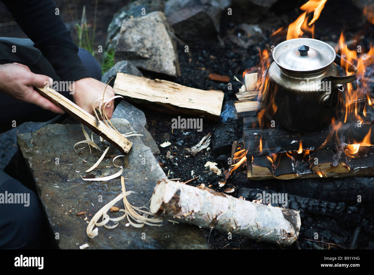 A man making a camp fire Sweden Stock Photo - Alamy