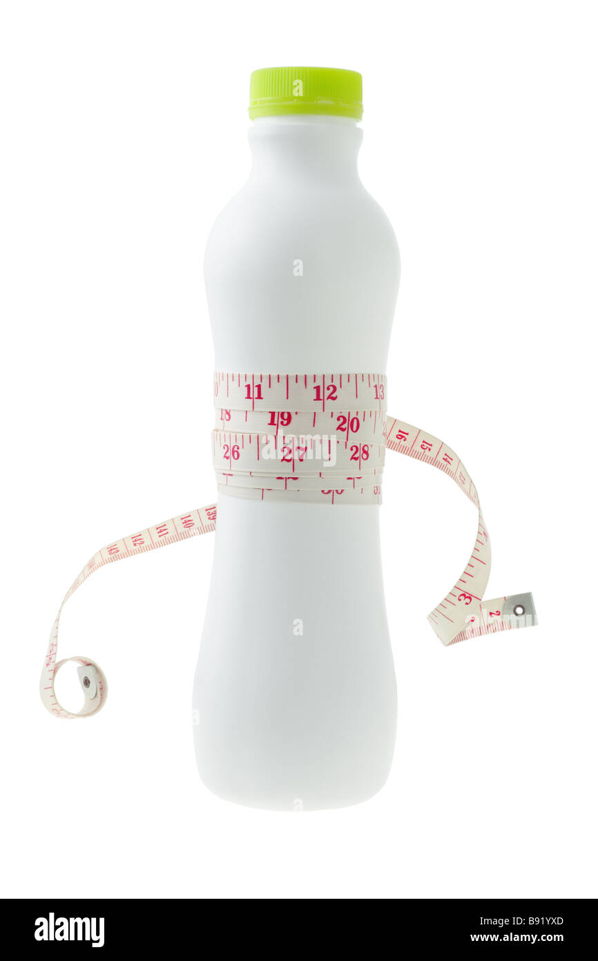 Tape measure wrapping round mid section of milk bottle on white ...