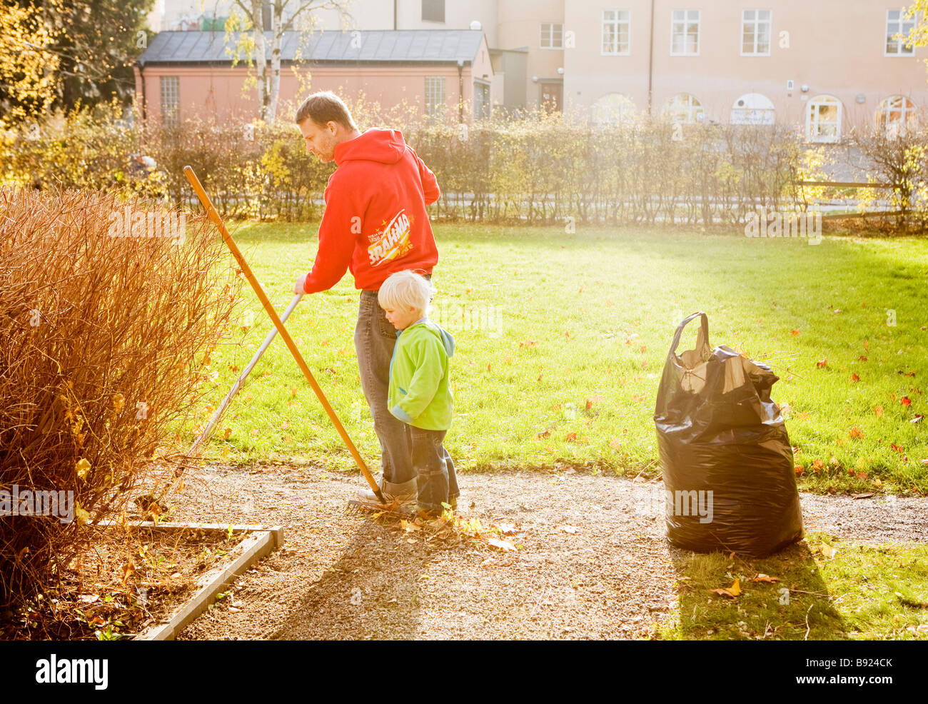 Boys outside home with rakes hi-res stock photography and images - Alamy