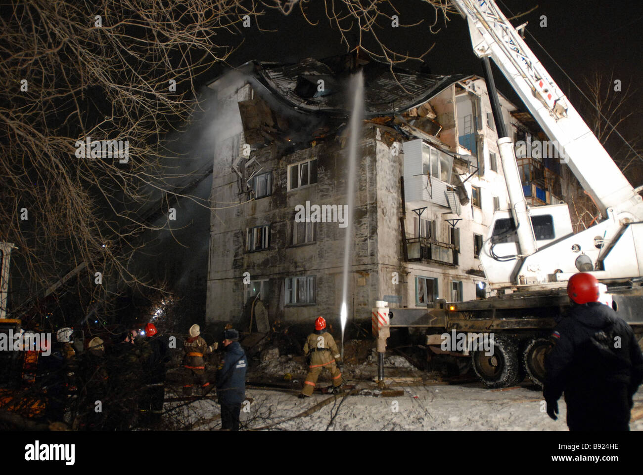 Clearing the debris after a gas explosion in an apartment building in ...