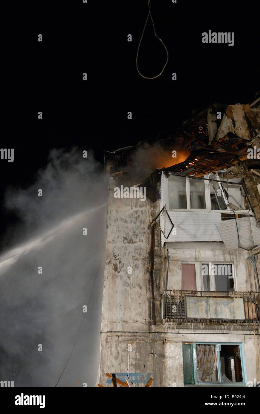 Putting out the fire after a gas explosion in an apartment building in ...