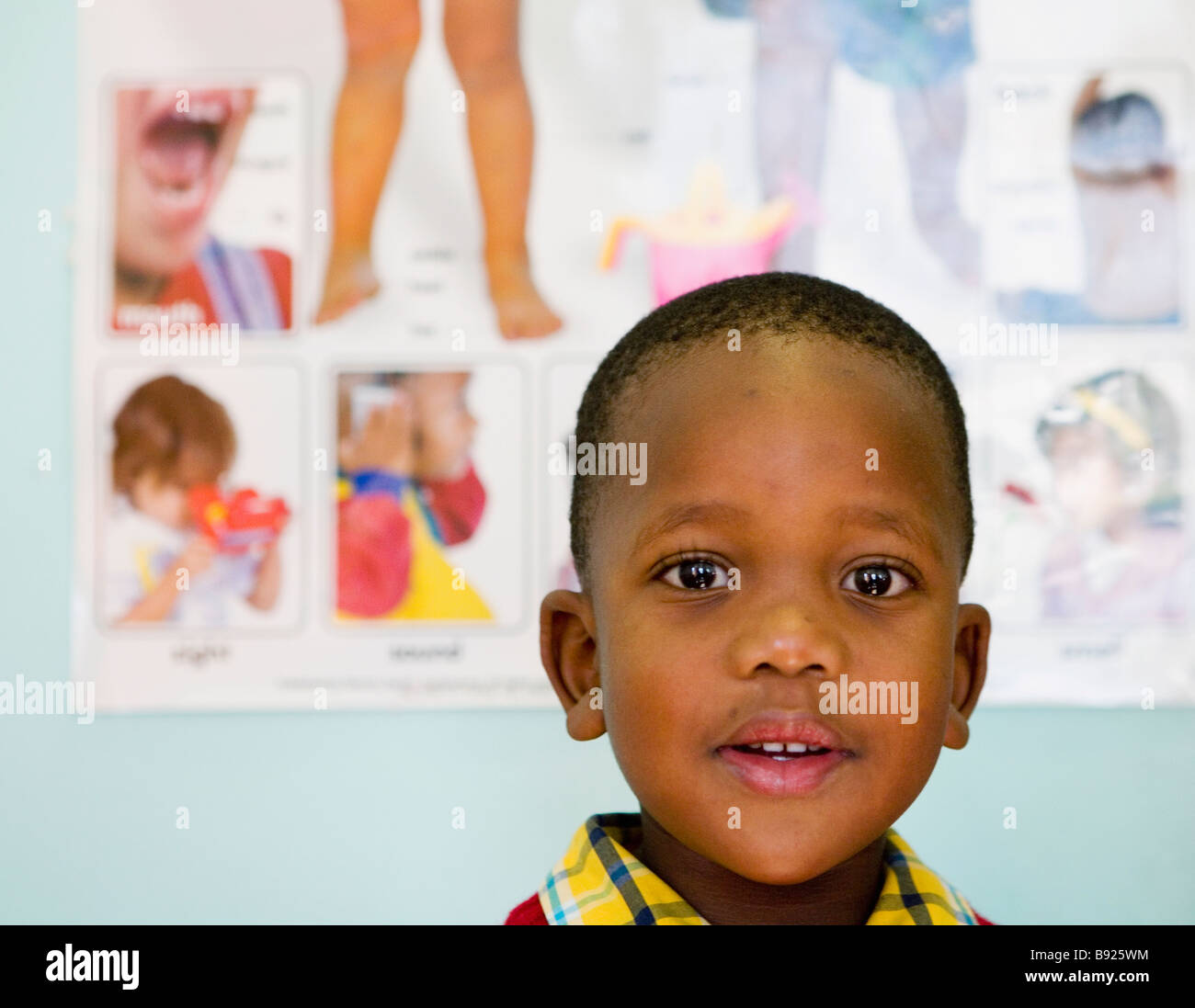 Child at creche in front of educational poster Franschhoek Western Cape ...