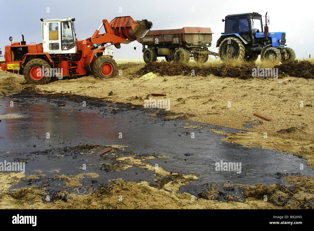 Cleaning the shores of oil residue after several vessels wrecked in the ...