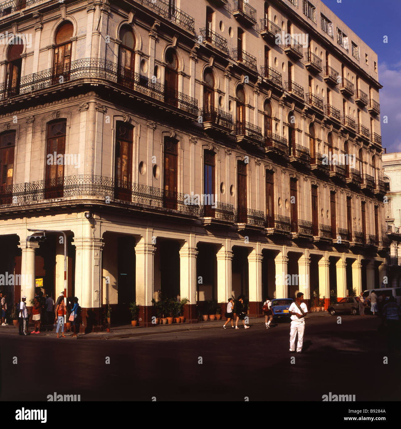 Cuban in white stands outside building in Havana, Cuba Stock Photo - Alamy