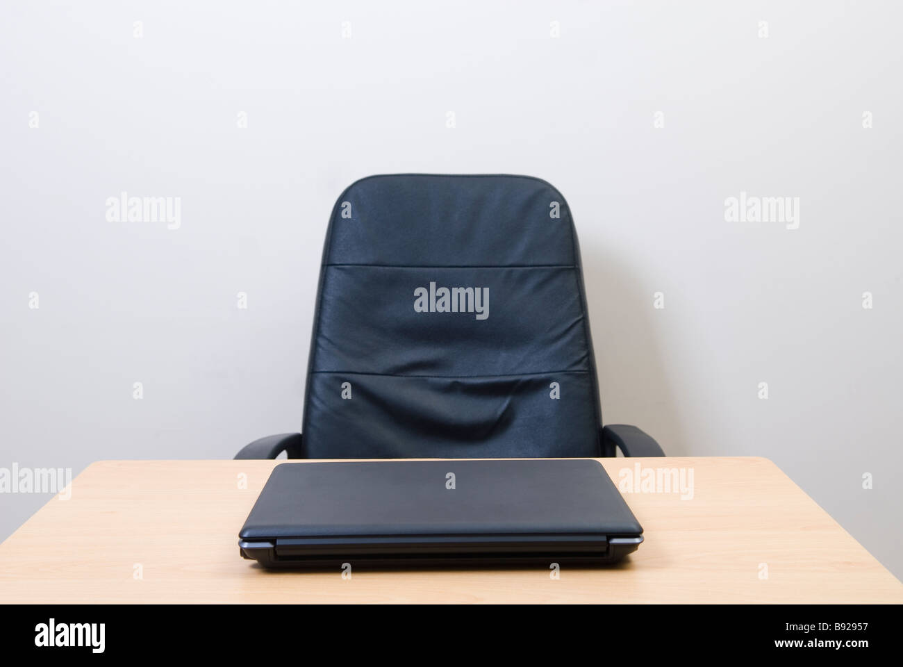 Leather chair and a laptop inside an office Stock Photo - Alamy