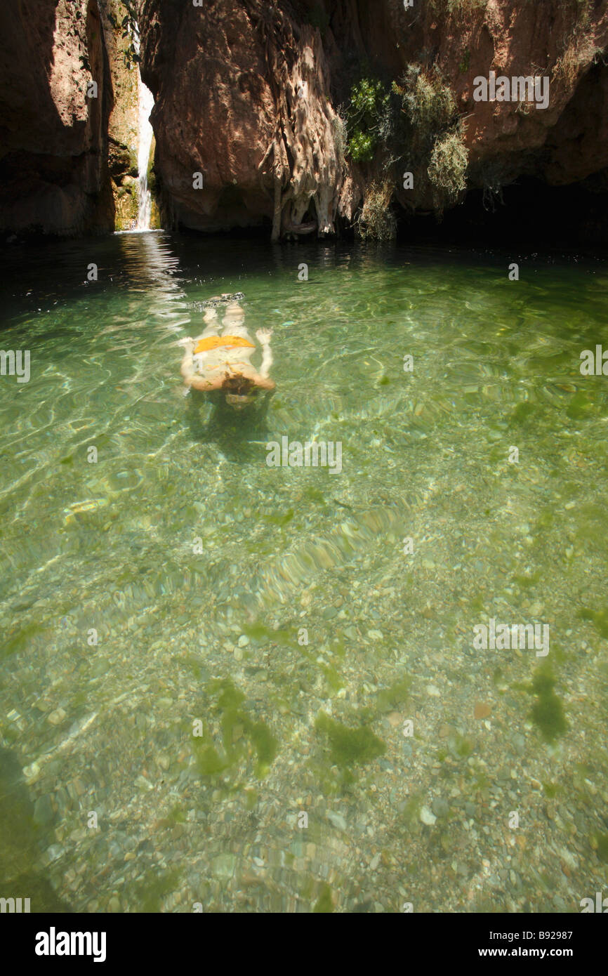 Woman Swimming underwater in crystal clear hot spring in Desert Ongongo ...