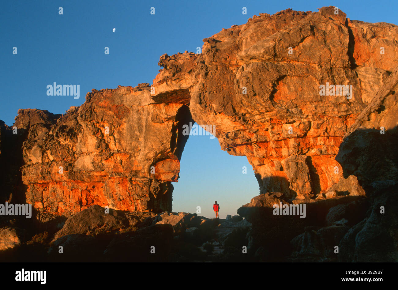 Woman standing underneath rock arch Wolfberg Arch Cederberg Western ...