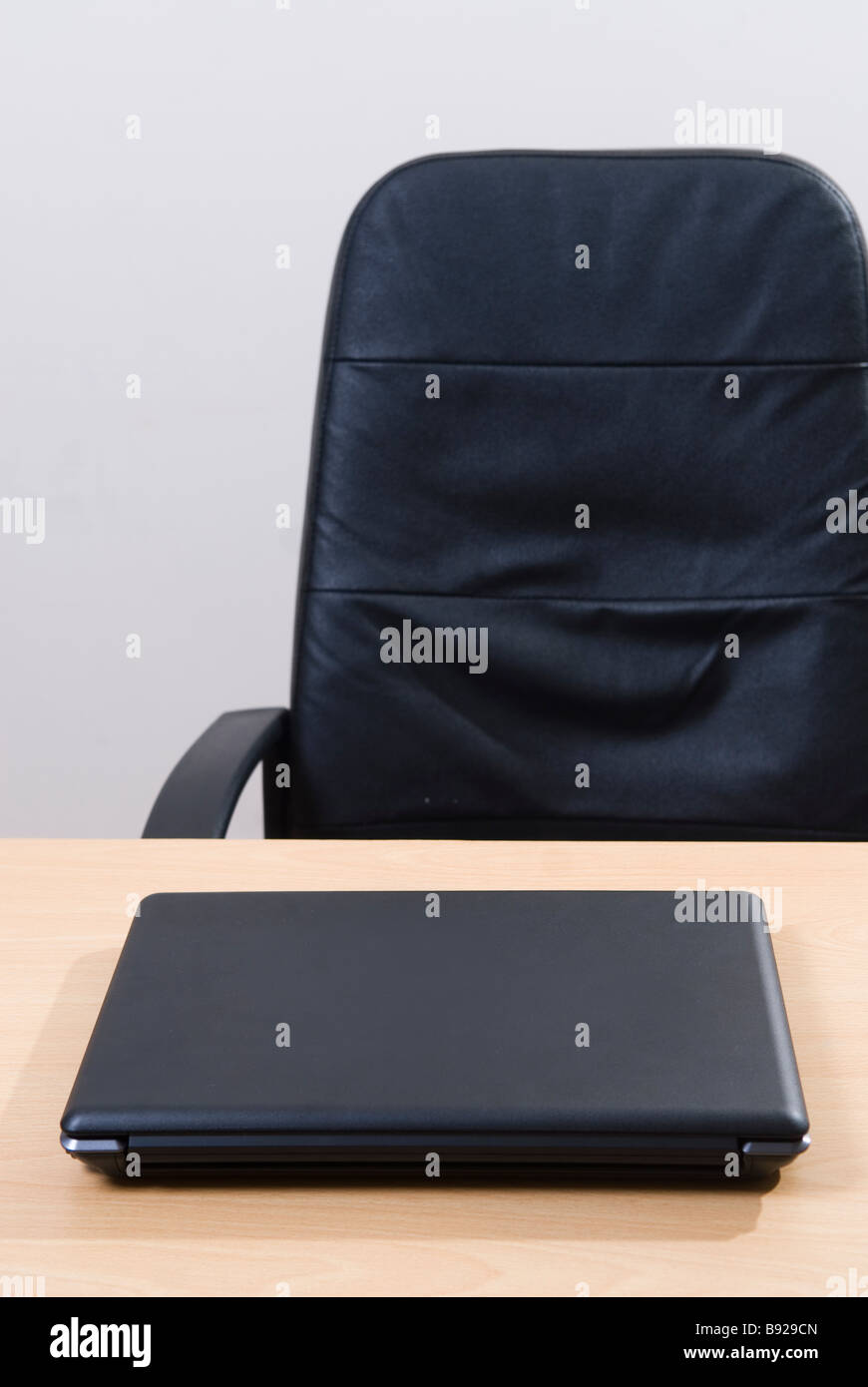 Leather chair and a laptop inside an office Stock Photo - Alamy