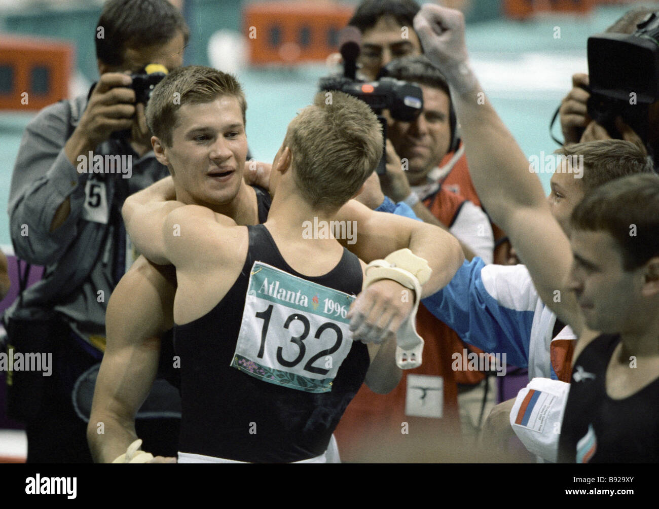 Russian gymnast Alexei Nemov second left receiving compliments from his ...