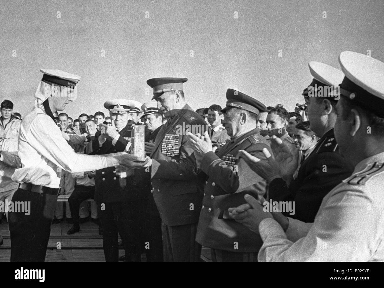 Crew of the Dzerzhinsky cruiser presents a cruiser model to the Soviet ...