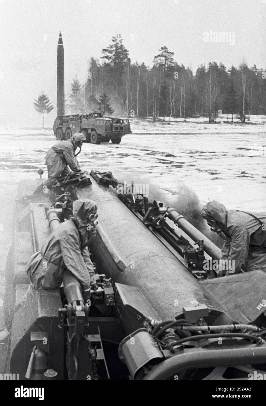 Missile troopers in gas masks are preparing the launch of a missile ...