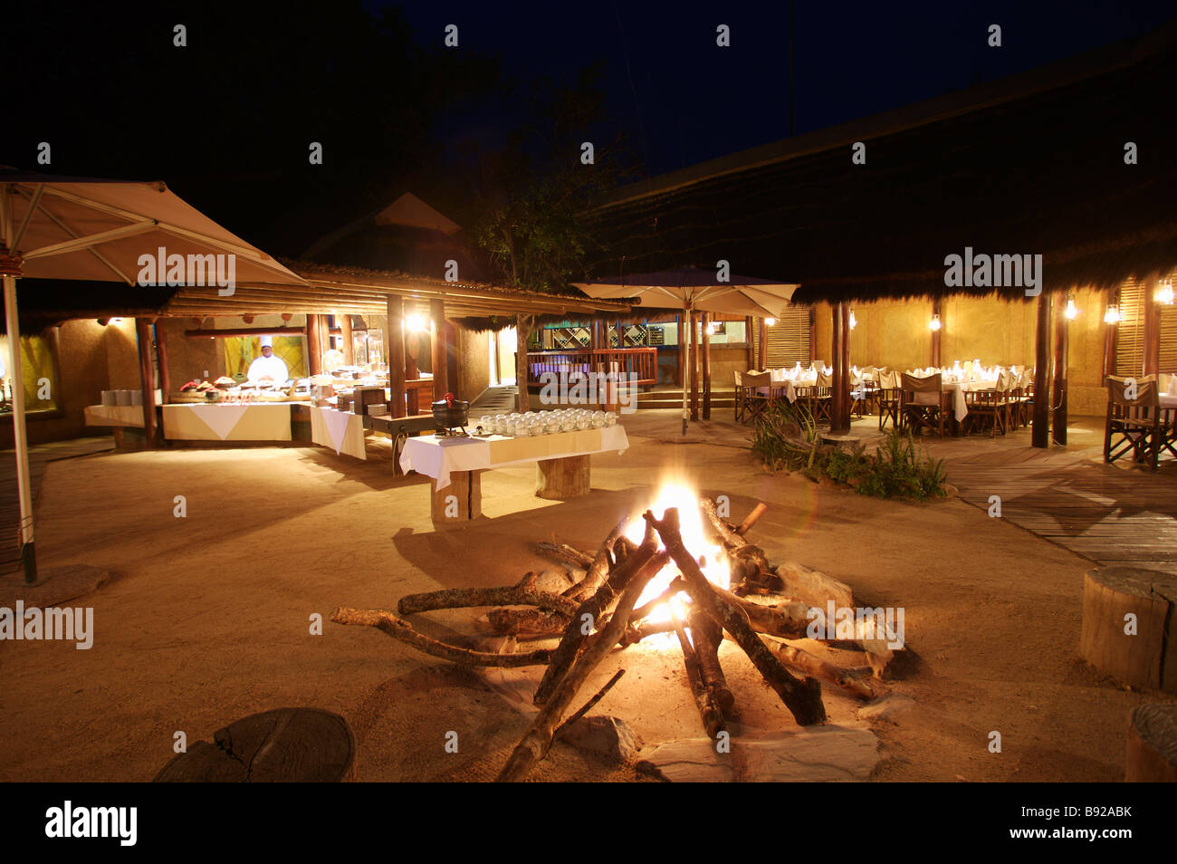 Bonfire in the middle of the lodges with buffet set up in background ...