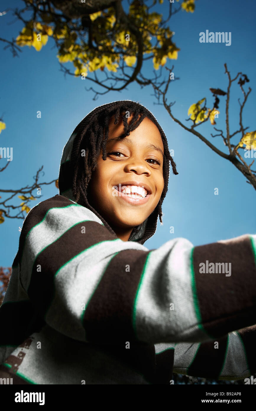 Low angle view of boy climbing tree Zoolake Park Johannesburg Gauteng ...