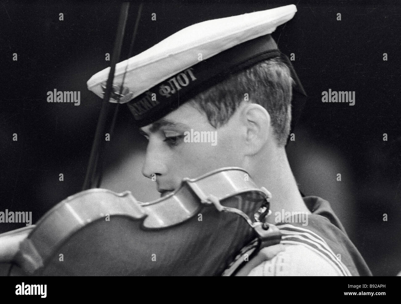 A sailor plays the violin during a Dzerzhinsky cruiser home talents ...