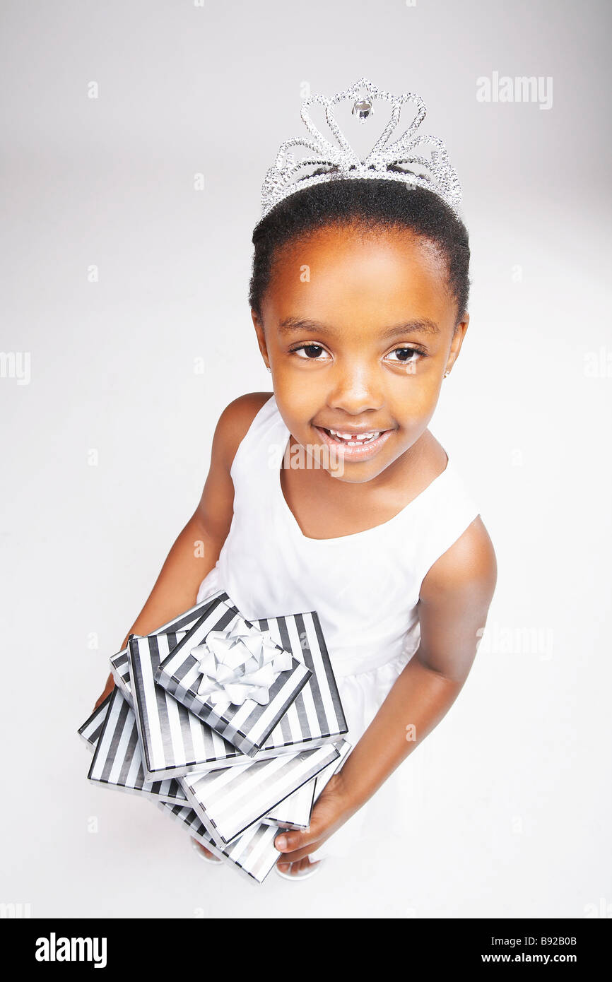 High angle shot of young girl wearing tiara holding gifts Stock Photo ...