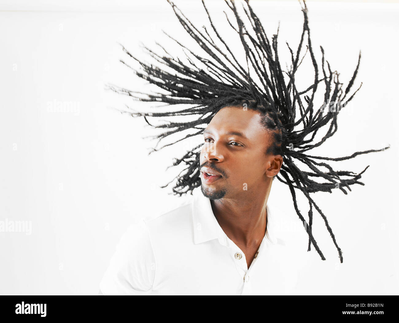 Man flicking hair around white background Stock Photo - Alamy