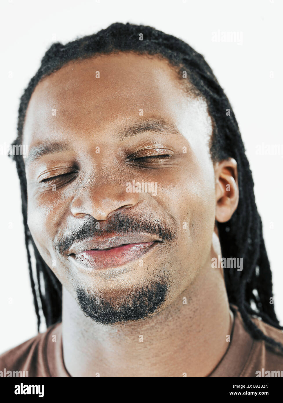 Man smiling with eyes closed Stock Photo - Alamy
