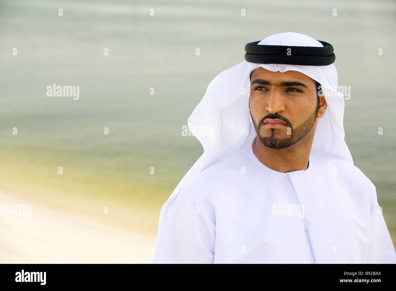 Arab man standing on the beach Stock Photo - Alamy