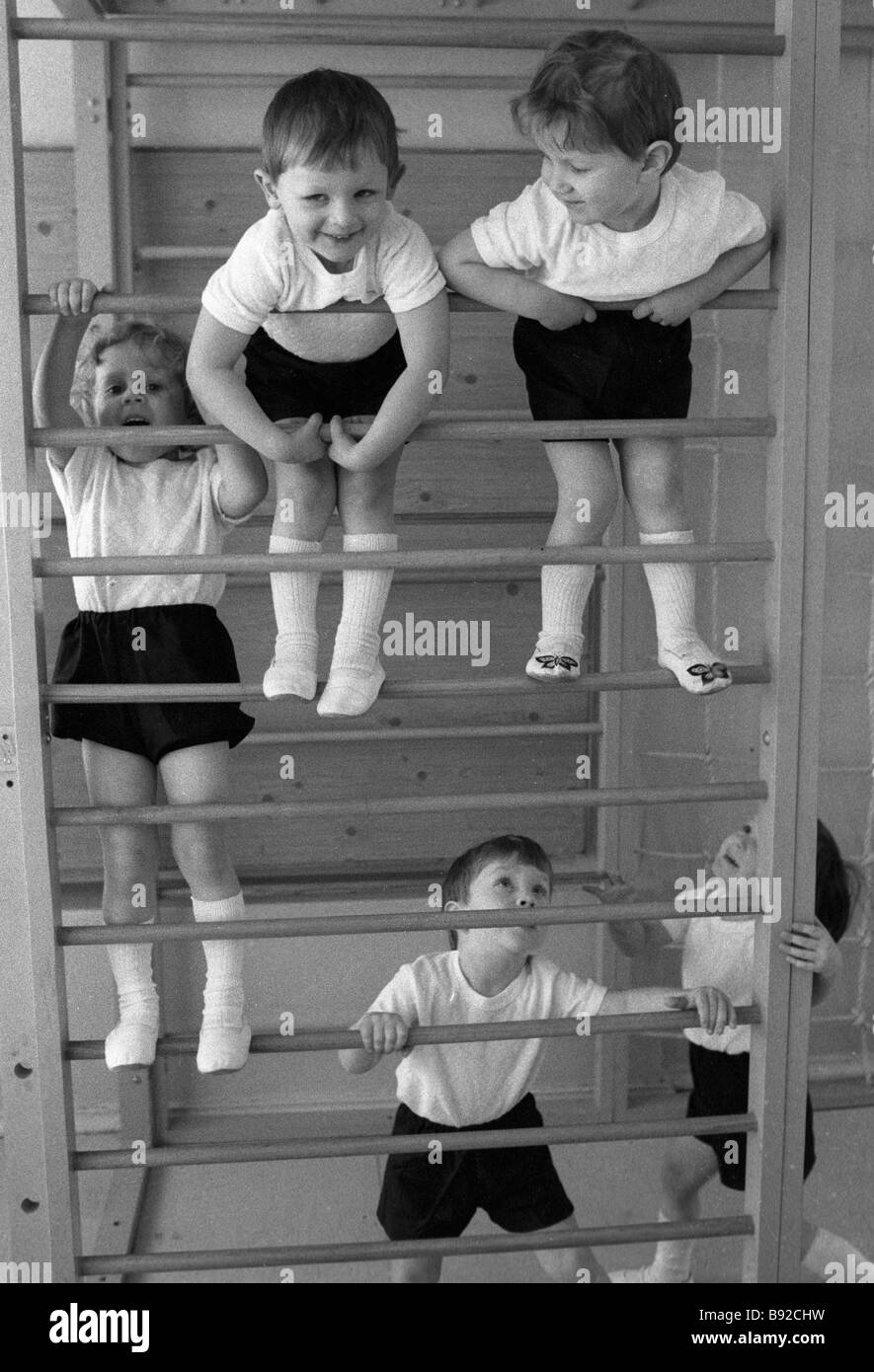 Physical exercise in a kindergarten children at the wall bars Stock ...