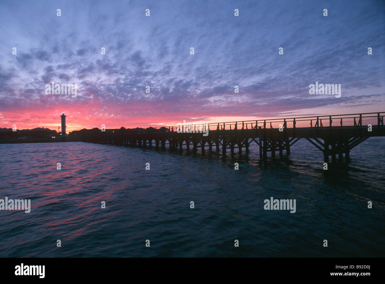 Sihouette of old causeway and lighthouse at sunset Milnerton Woodbridge ...