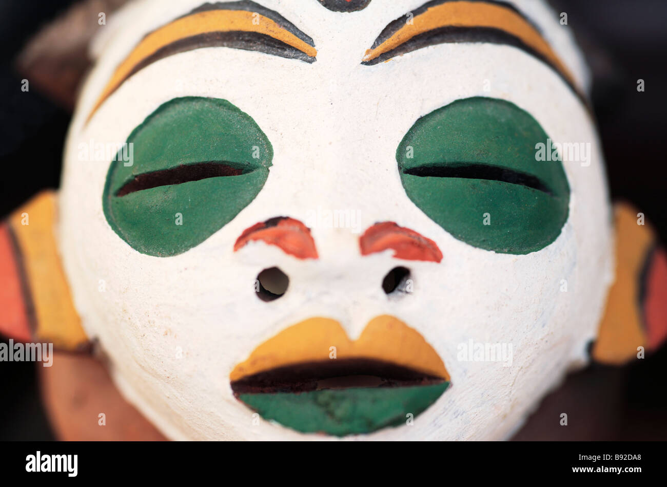 Close up of a brightly painted West African mask Grahmastown Eastern ...