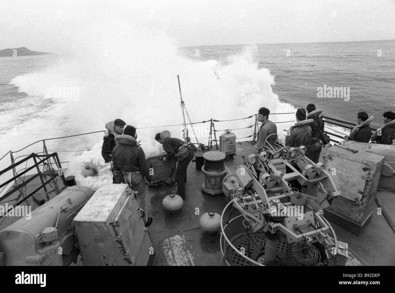 Navy men of the Pacific Fleet lay a smoke screen from a missile boat ...