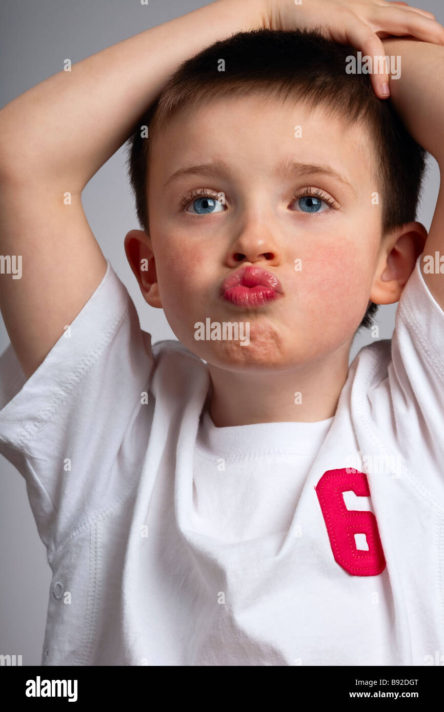 Little boy mimicking a monkey Stock Photo - Alamy
