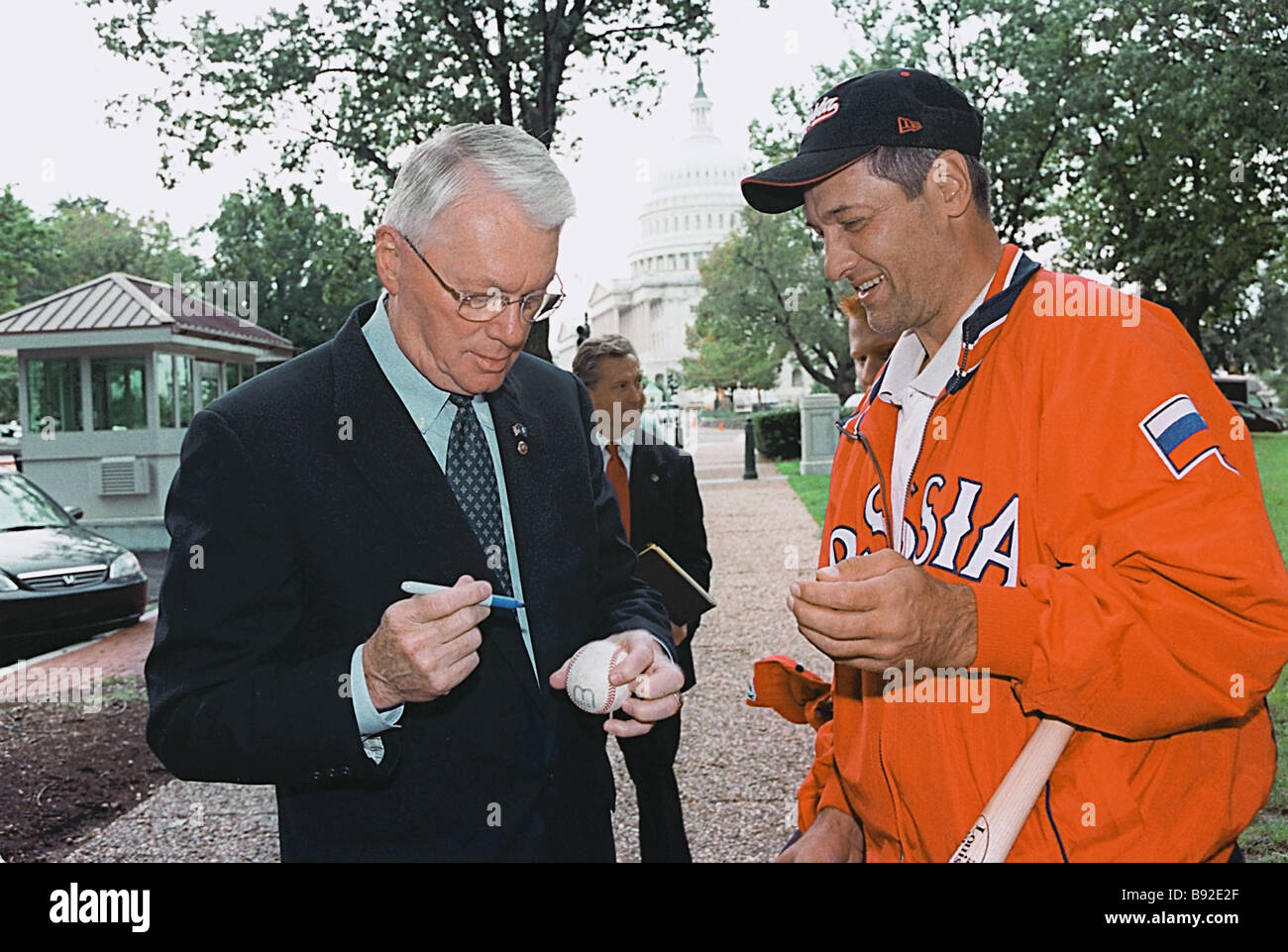 U S Senator Jim Bunning giving an autograph to a Russian coach during a ...