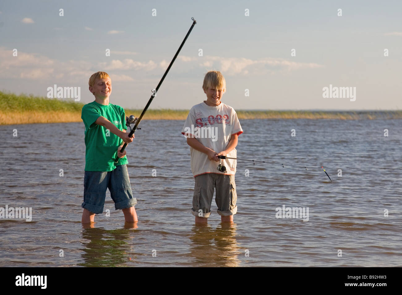Two boys holding two fish hi-res stock photography and images - Alamy