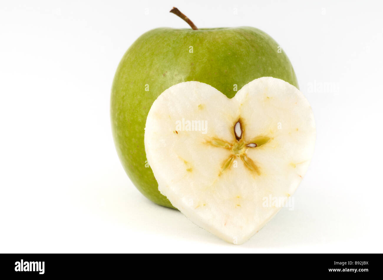 Apple heart and a green apple on a white background Stock Photo - Alamy