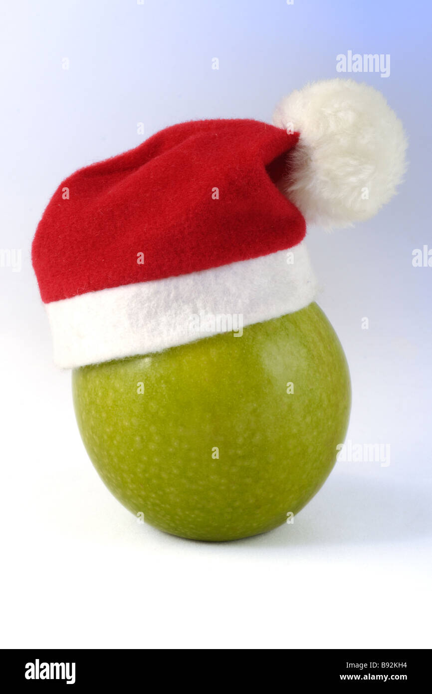 Green apple with a christmas hat Stock Photo - Alamy