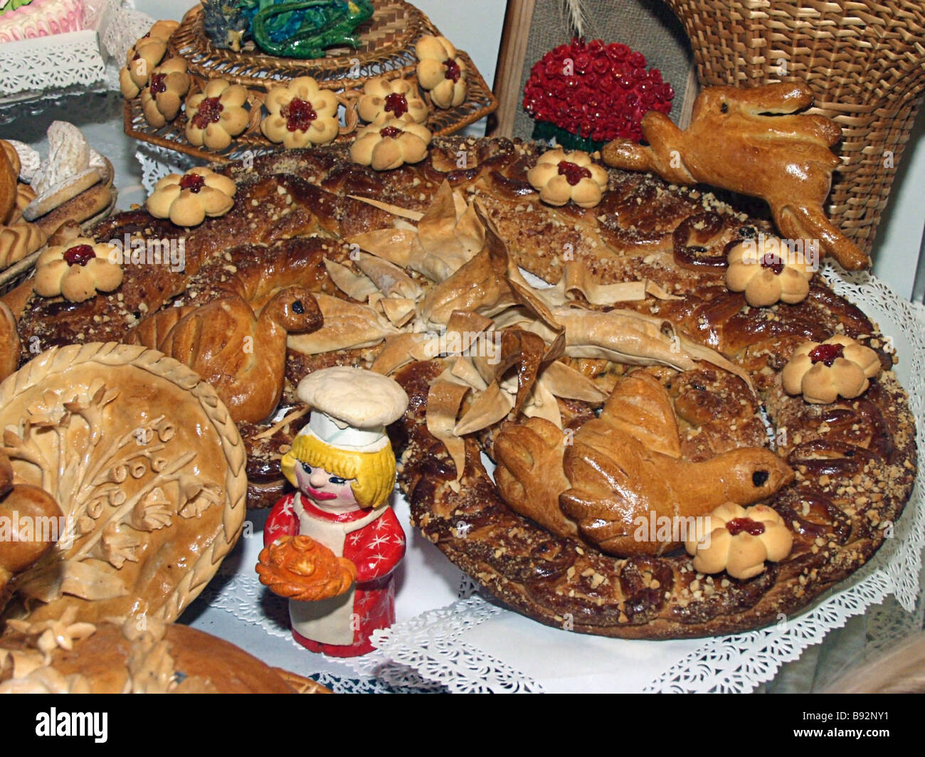 A composition of fancy pastries and folk style toys at the ...