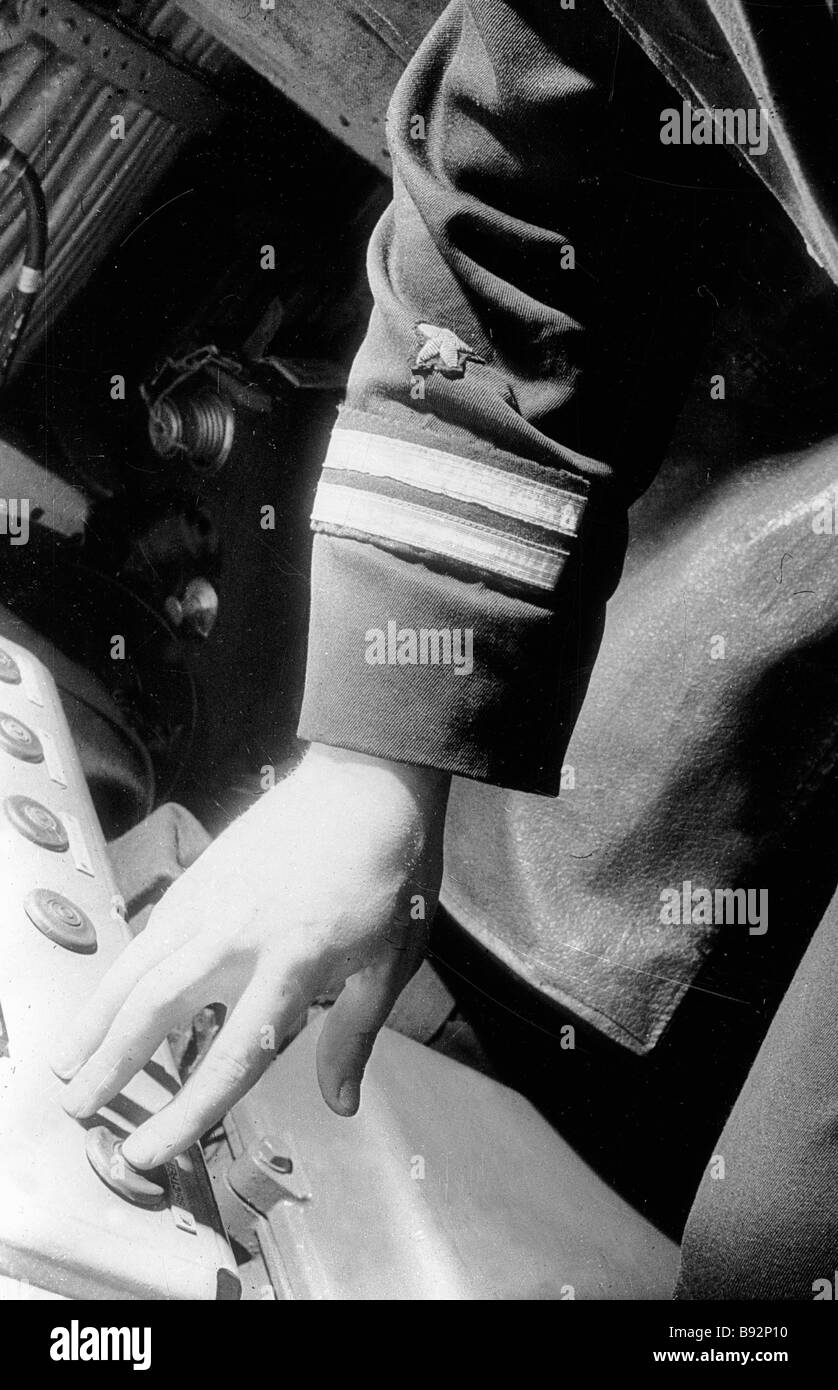 A seaman holds his hand on the control panel of a submarine Stock Photo ...