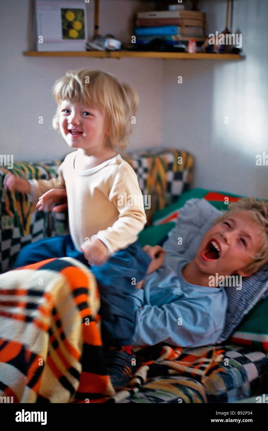 BOY 2 YEARS JUMPING ON HIS BROTHER BELLY Stock Photo - Alamy
