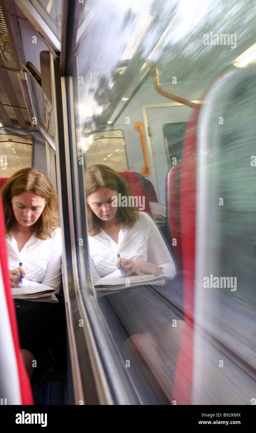 Reflection of train passenger with blurred scenery through the window ...