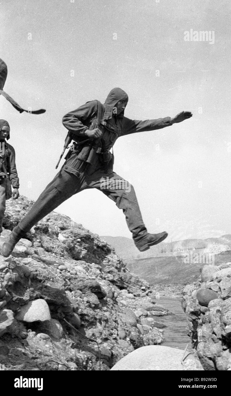 A paratrooper jumps over the ditch Stock Photo - Alamy