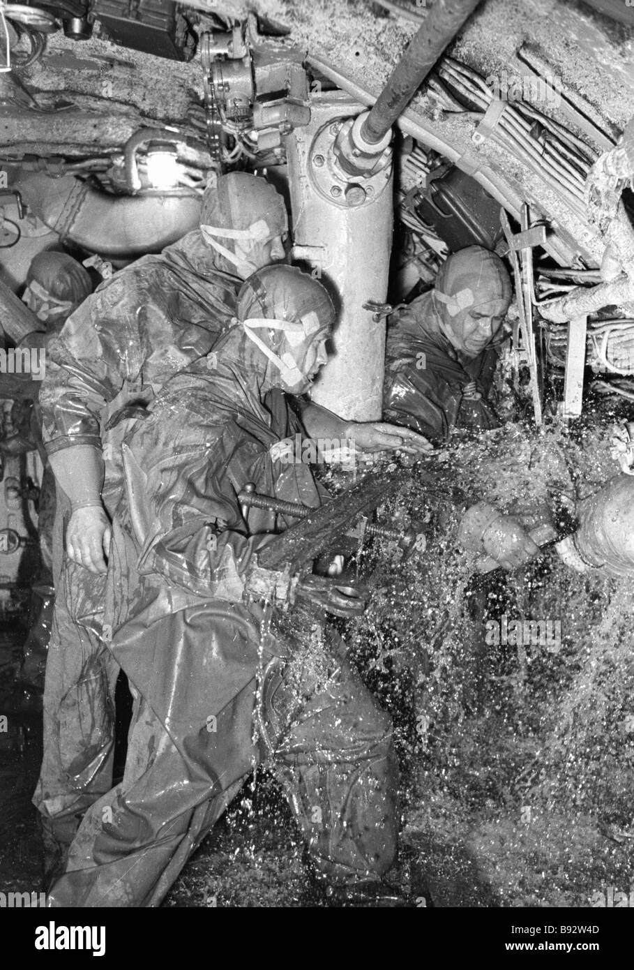 Sailors plugging in a hole in the ship s hull during a survivability ...