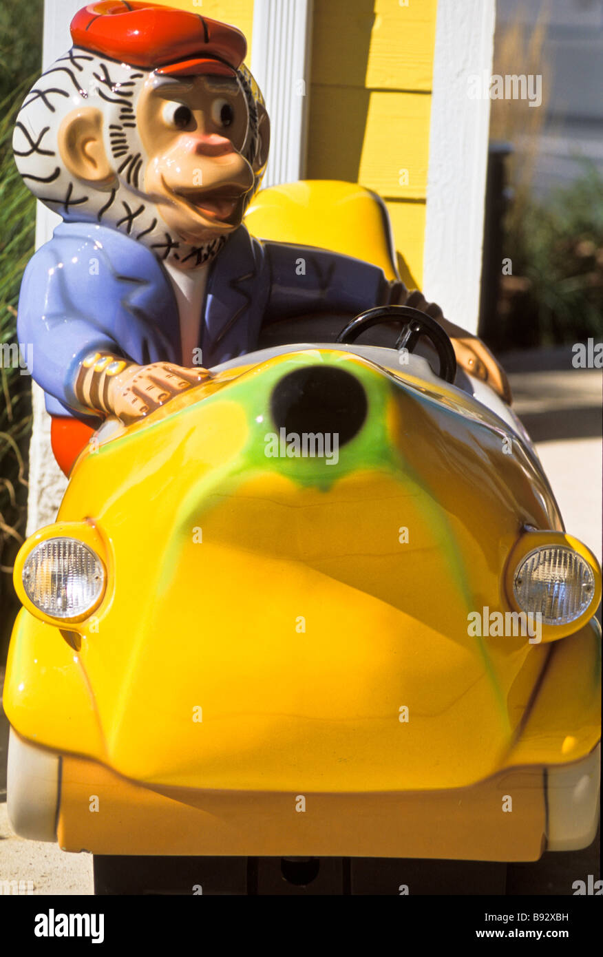 Childrens amusement park style ride, funny monkey yellow car Stock ...