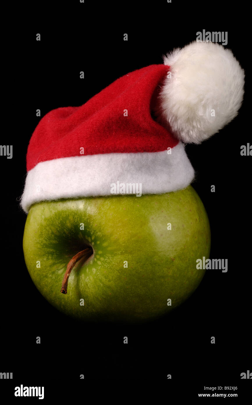 Green apple with a christmas hat Stock Photo - Alamy