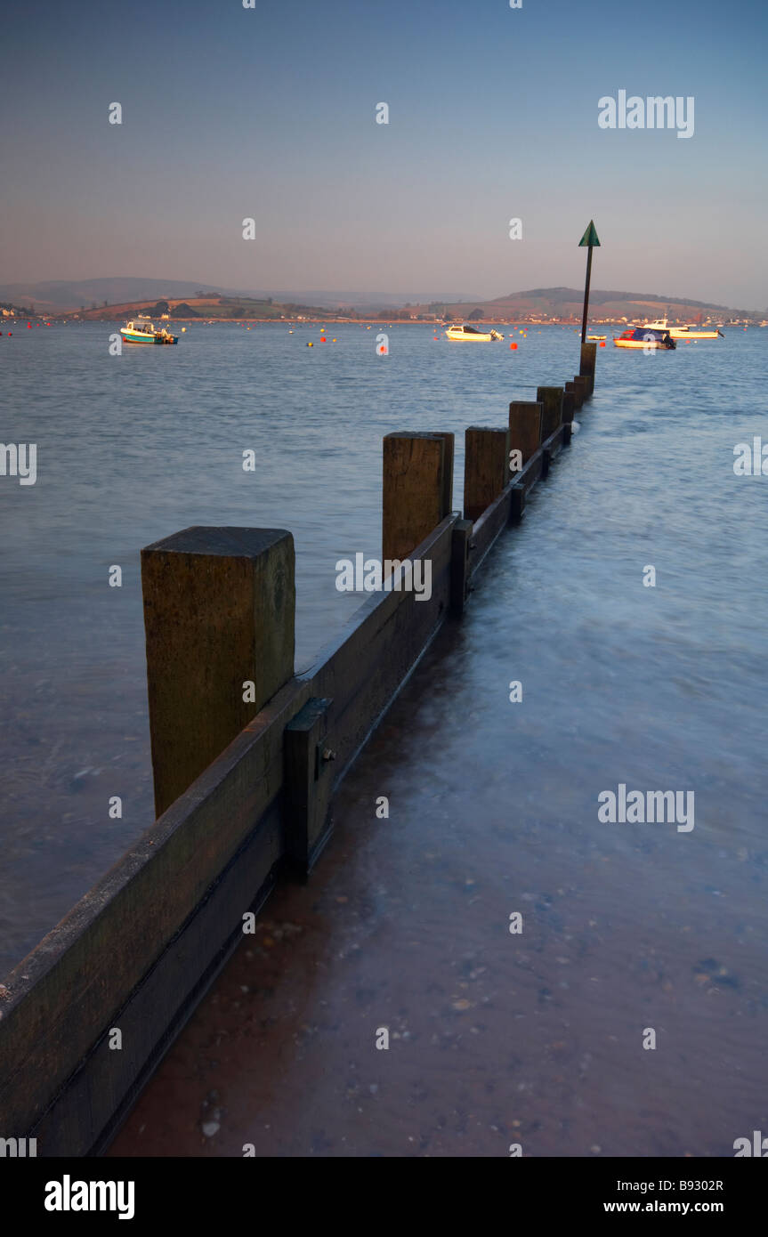 Dawn light illuminates fishing boats and yachts on the Exe estuary ...